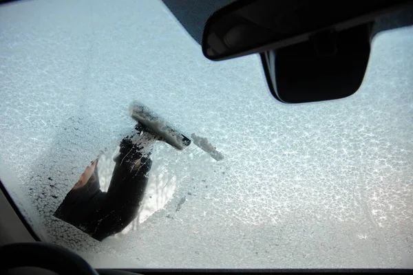 Clean car window from snow in winter time. Windshield cars cleaning ...