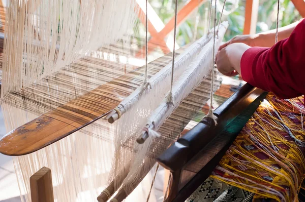 Woman weaving silk in traditional way - Stock Image - Everypixel