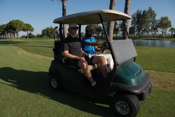 Golf players driving cart at course - Stock Image - Everypixel