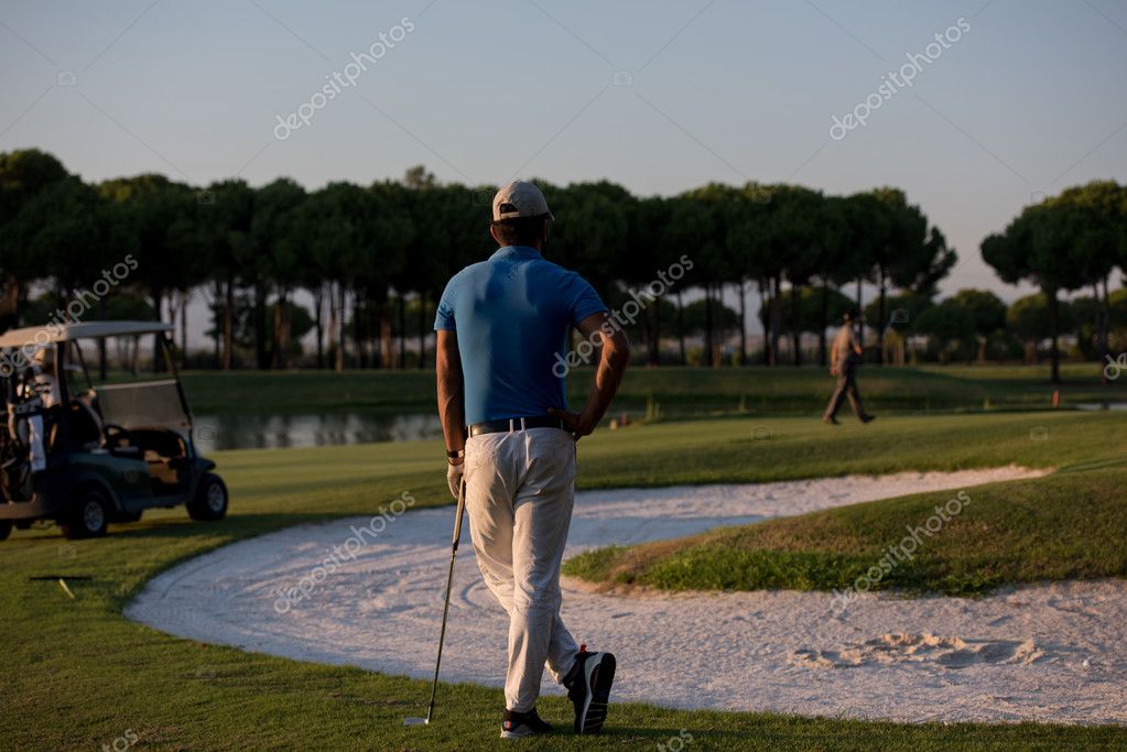 Golfer from back at course looking to hole in distance Stock Photo by ...