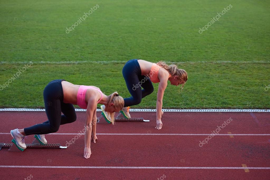 Athlete women group running on athletics race track Stock Photo by ...