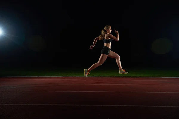 Athletic woman running on track - Stock Image - Everypixel