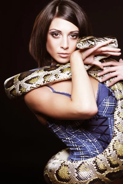 Sexy brunette holding python Stock Photo by ©kanareva 65840419