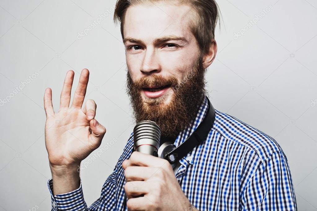 Young man holding a microphone Stock Photo by ©kanareva 70759921