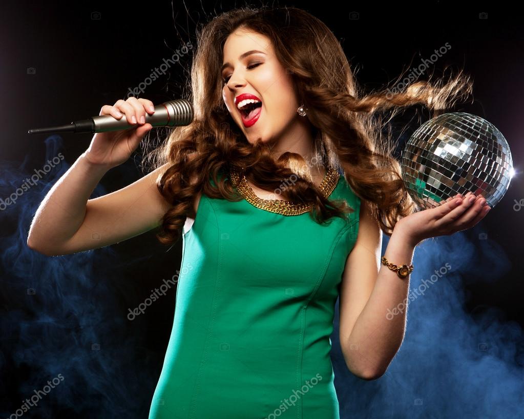 Young girl singing into microphone at party Stock Photo by ©kanareva ...