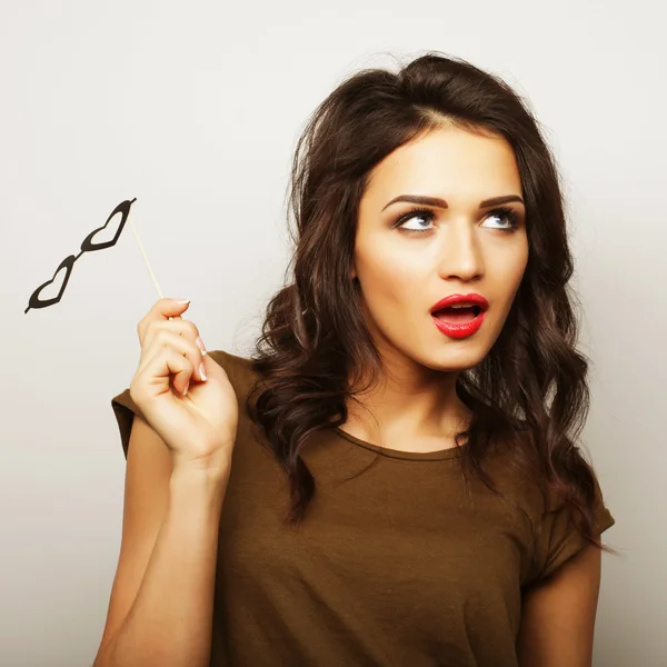 Party image. Playful young woman holding a party glasses. Stock Photo ...