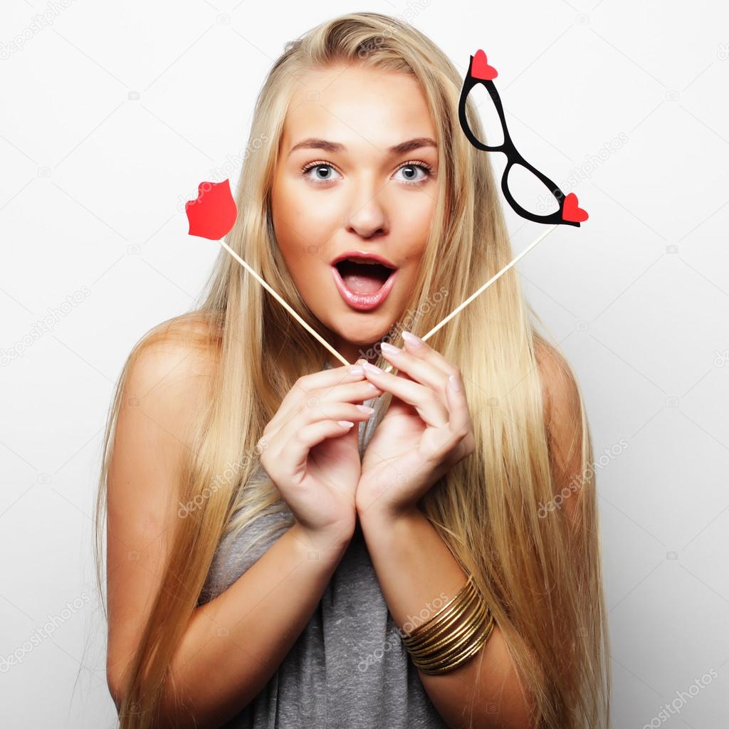 Party image. Playful young woman holding a party glasses. Stock Photo ...