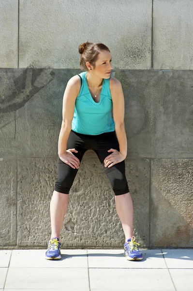 Fit woman resting after run in the city. Jogger. - Stock Image - Everypixel