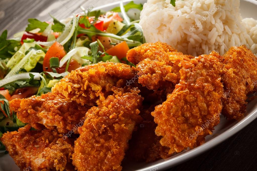 Fried chicken nuggets with rice and vegetables — Stock Photo © gbh007 ...