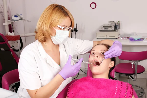 Dentist gives the patient an injection - Stock Image - Everypixel