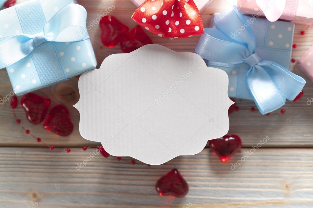 Blank label and gift boxes on wooden background Stock Photo by ©digieye ...