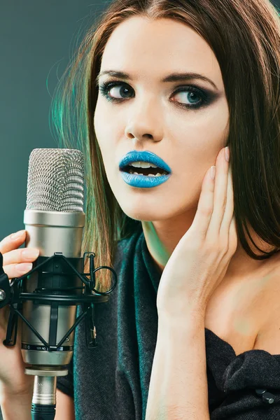 Model singing into microphone - Stock Image - Everypixel