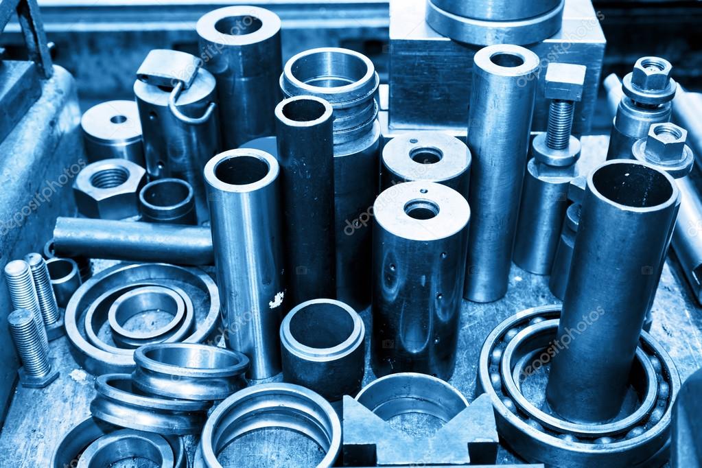 Steel cylinders, pistons and tools in workshop. — Stock Photo ...