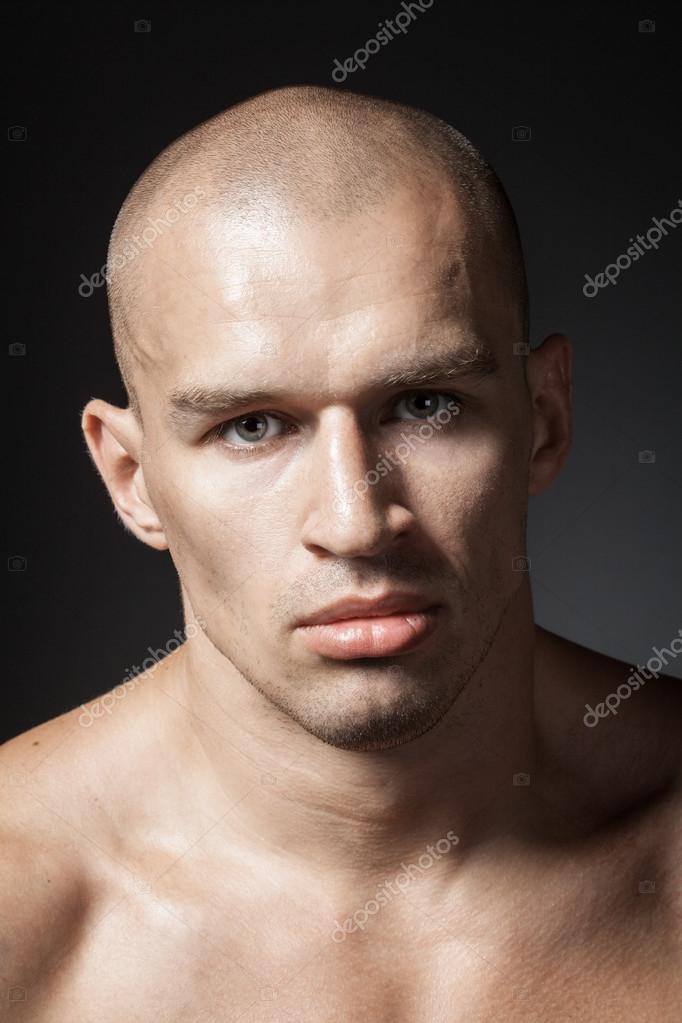 Strong man portrait isolated on dark background — Stock Photo © tiler84 ...