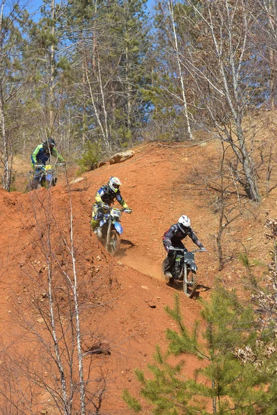 Enduro motorcycles descend from the steep slope on the mountain - Stock ...