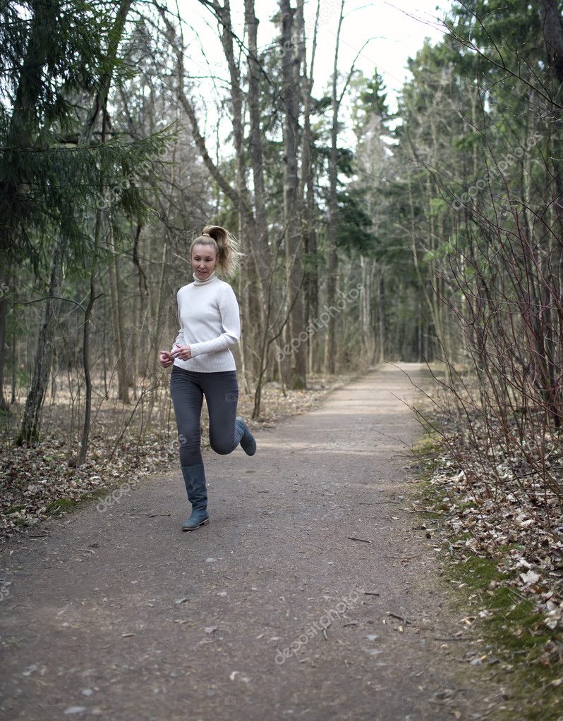 The woman runs on the track in the spring wood Stock Photo by ©KKulikov ...