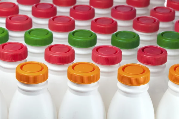 Dairy products bottles with bright covers - Stock Image - Everypixel