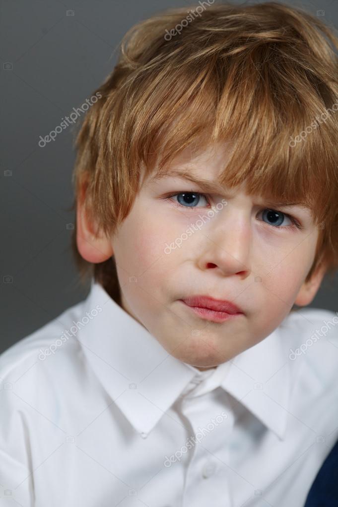 Little serious boy portrait on dark Stock Photo by ©ababaka 121675964