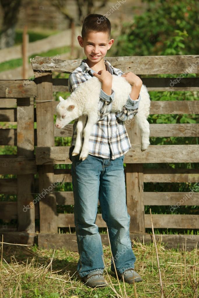 Boy with lamb on the farm Stock Photo by ©ababaka 80151296