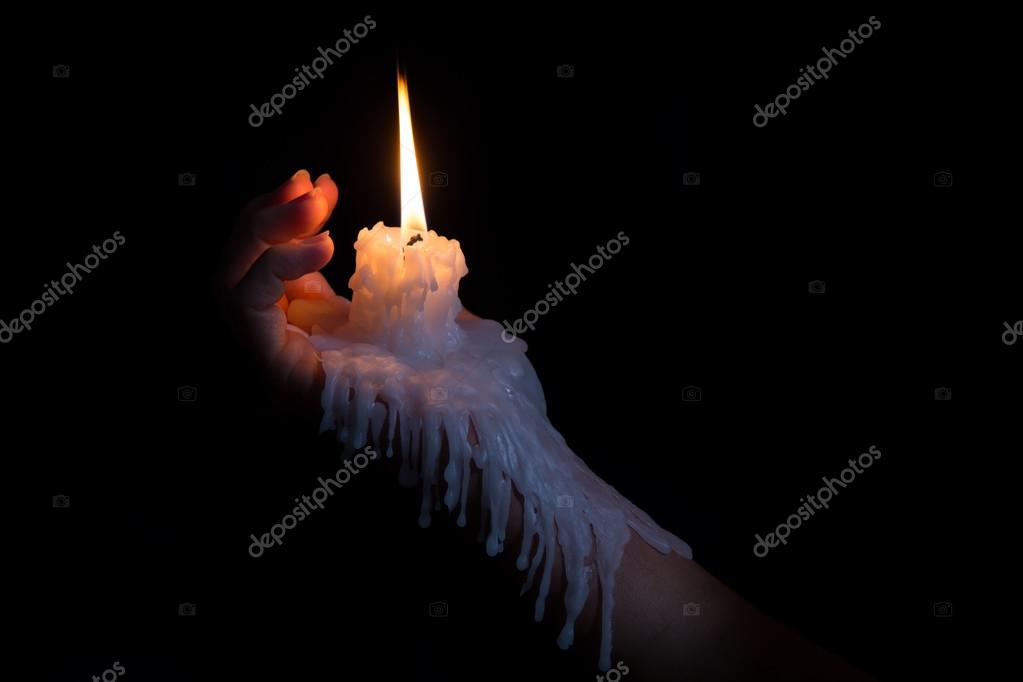 Open hand holding candle stick with wax flowing down the arm Stock ...
