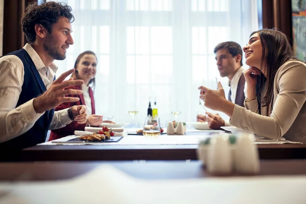 Young people talking at business lunch in a cheerful atmosphere at the ...