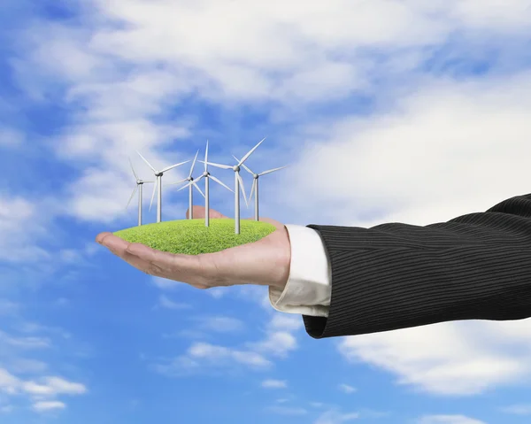 Human hand holding wind turbine on globe Stock Photo by ©bruesw 100850356