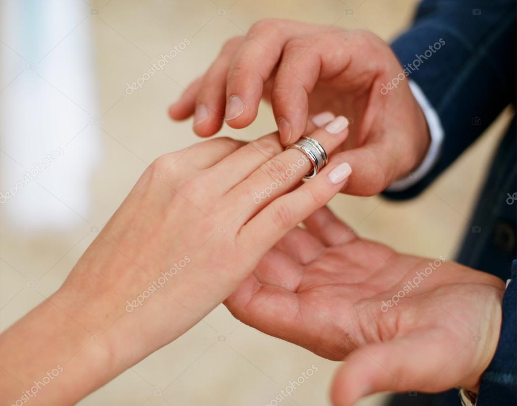 Man making proposal with the ring to his girlfriend. Put ring on hand ...