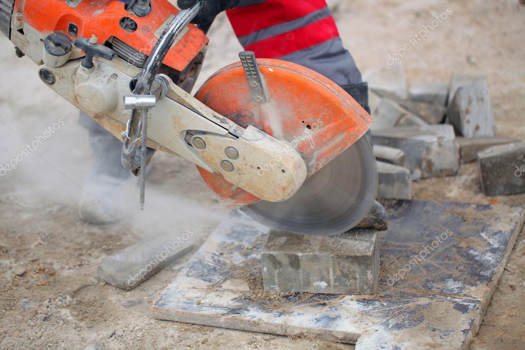 Construction worker using concrete saw — Stock Photo © Omstudio #66474527
