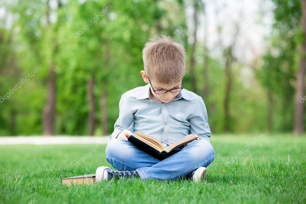Happy young boy with a books Stock Photo by ©massonforstock 73024209