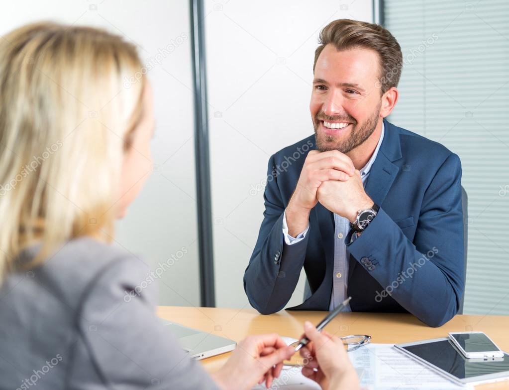 Young attractive employer doing a job interview to a woman Stock Photo ...