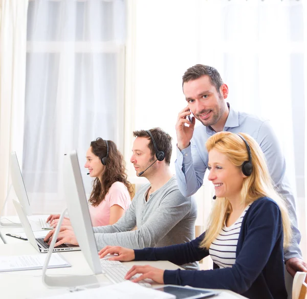 Manager training a young attractive people on computer - Stock Image ...