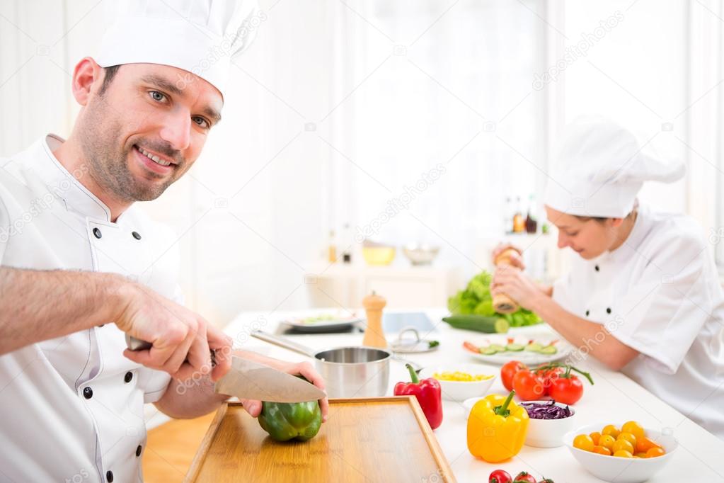 Young attractive professional chef cooking in his kitchen Stock Photo ...