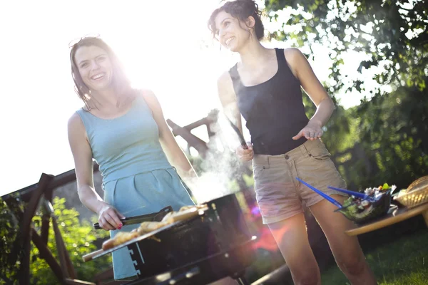 Girls making food on grill — Stock Photo © JanPietruszka #52066599