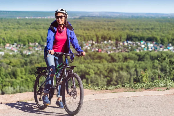 Beautiful young slim woman riding a bicycle - Stock Image - Everypixel