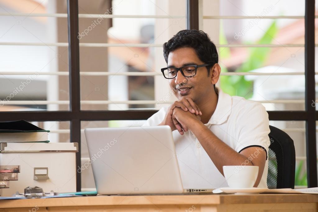 Indian man working at office Stock Photo by ©yuliang11 114818750
