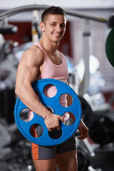 Fitness model posing holding weights - Stock Image - Everypixel