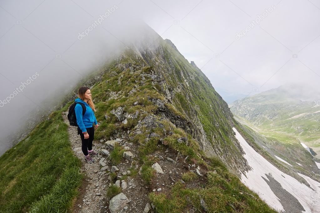 Woman walking on a trail Stock Photo by ©Xalanx 116492800