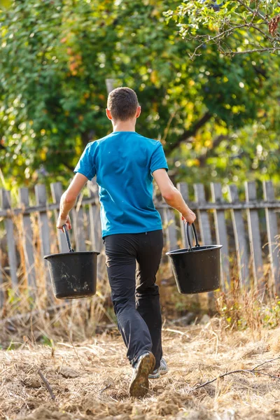 Carrying buckets Stock Photos, Royalty Free Carrying buckets Images ...