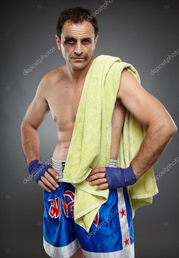 Bruised fighter with towel Stock Photo by ©Xalanx 52372433