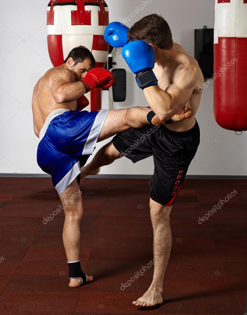 Kickbox fighters sparring in the gym — Stock Photo © Xalanx #63392381
