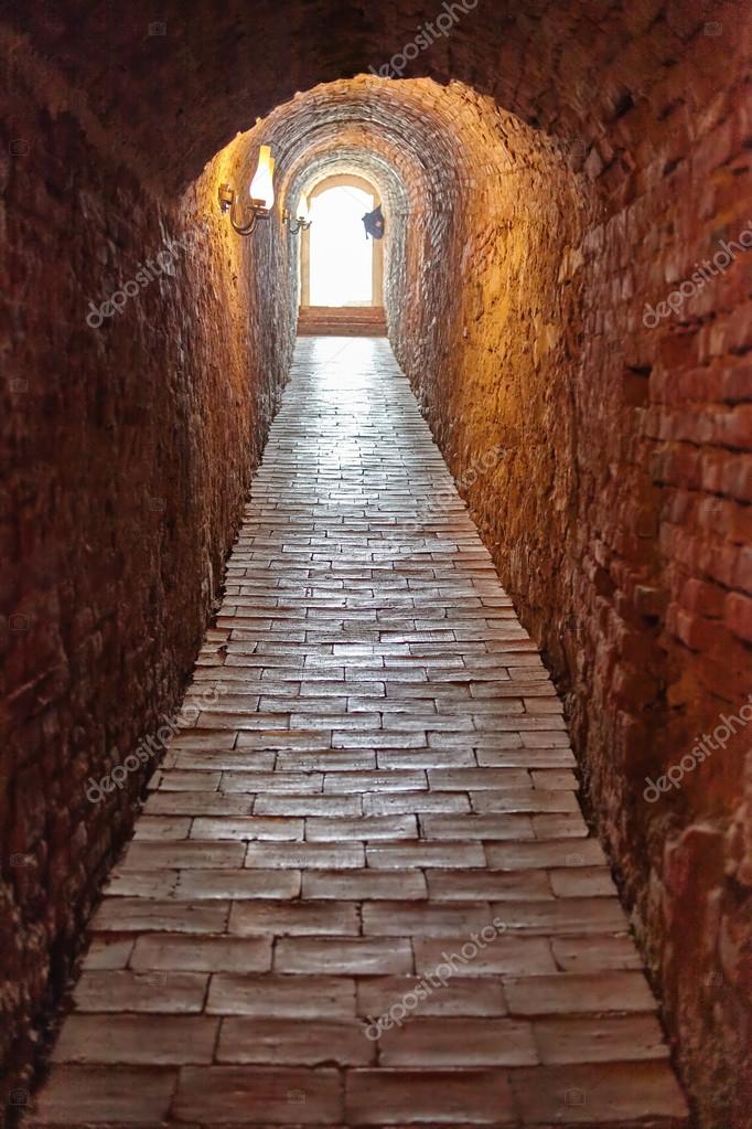 Tunnel through ancient castle Stock Photo by ©Xalanx 63907373