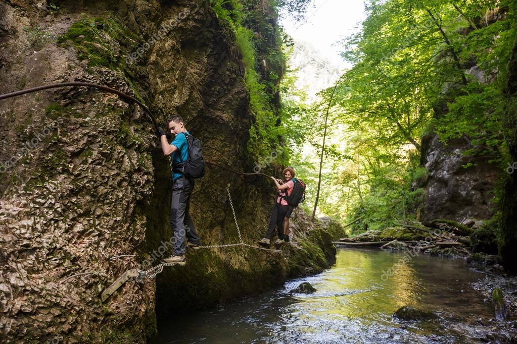 Hikers climbing above the river — Stock Photo © Xalanx #79671894