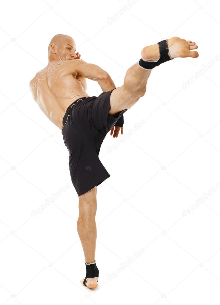 Kickboxer executing a powerful kick Stock Photo by ©Xalanx 80639314