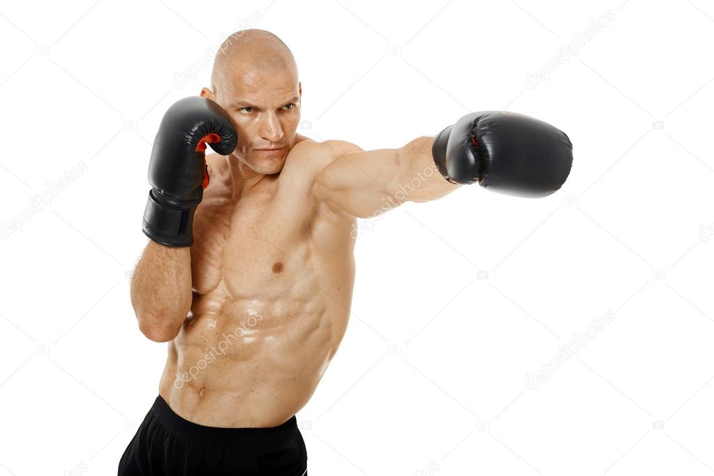 Very fit kickboxer punching Stock Photo by ©Xalanx 80639346