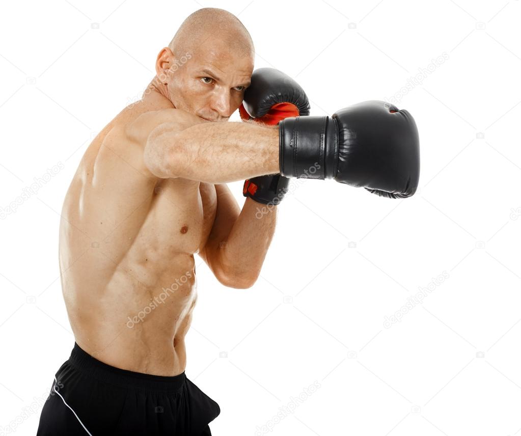 Very fit kickboxer punching Stock Photo by ©Xalanx 80639354