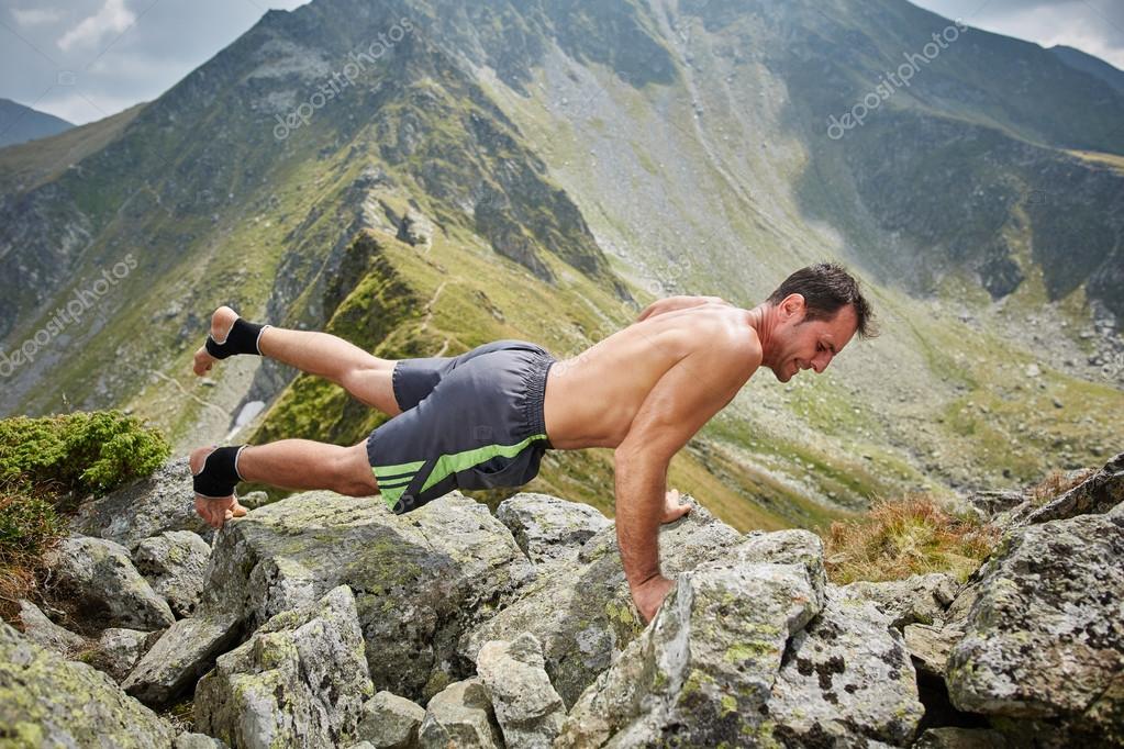 Active man doing exercises Stock Photo by ©Xalanx 85077784