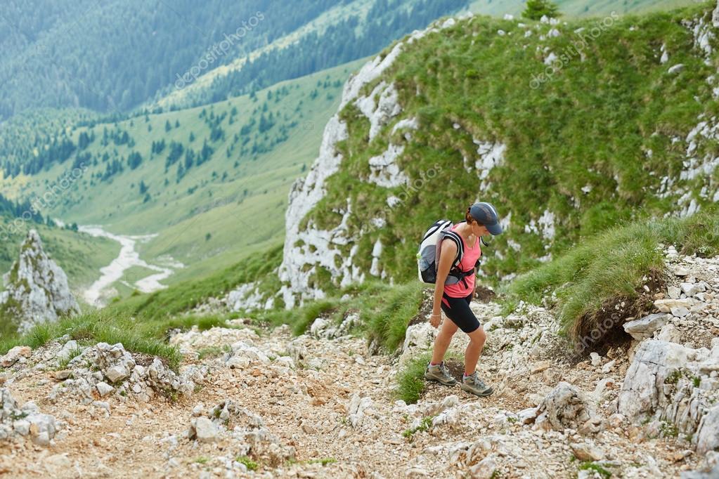 Woman walking a steep trail Stock Photo by ©Xalanx 85078152