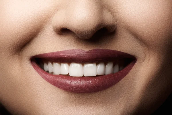 Close-up happy female smile with healthy white teeth, bright magenta ...