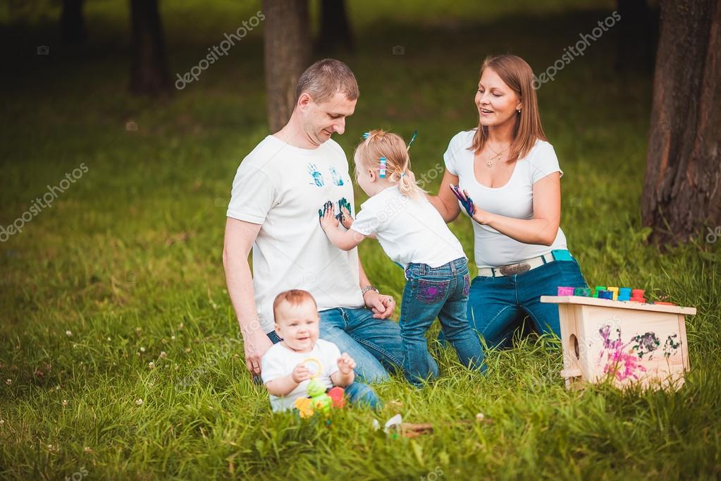 Happy family with nesting box and paints Stock Photo by ©Saksoni 63884437