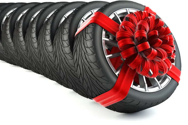 Tire wrapped in red gift ribbon Stock Photo by ©dimdimich 100556234